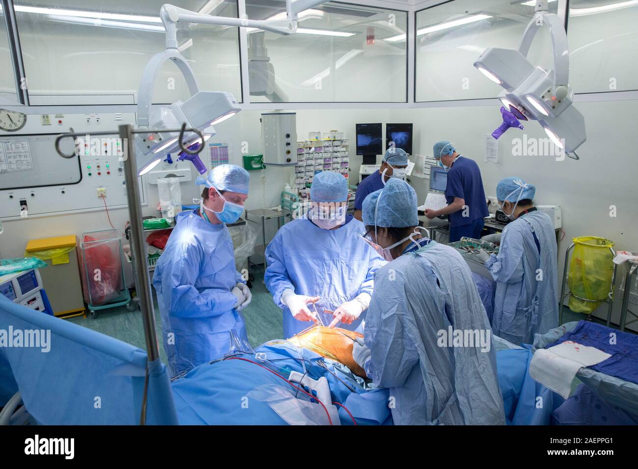 Surgeons at an NHS Hospital perform a knee operation, known as an ...