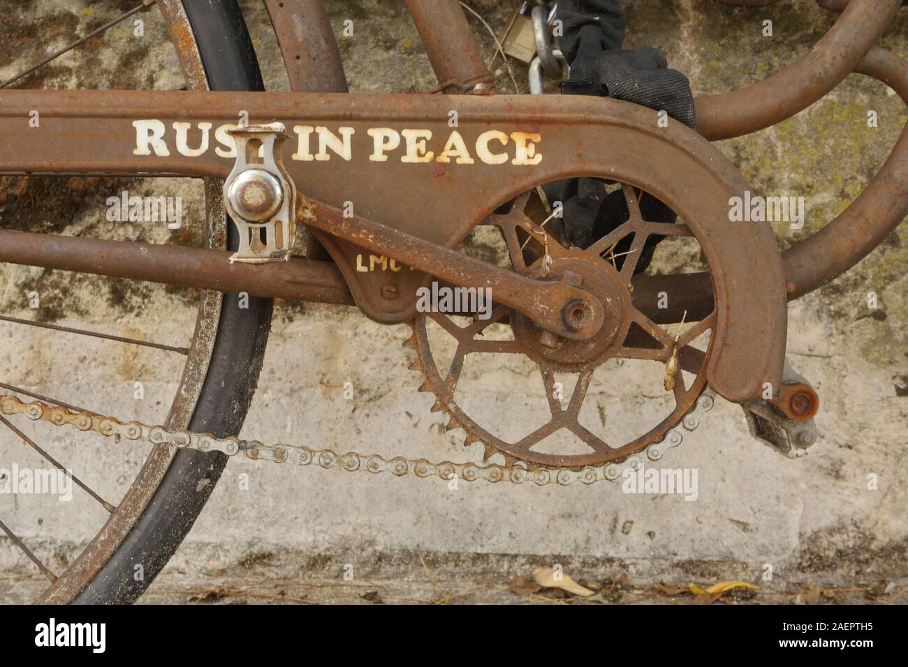 An old rusty bicycle chained to a wall in Paris.Rust in peace in ...