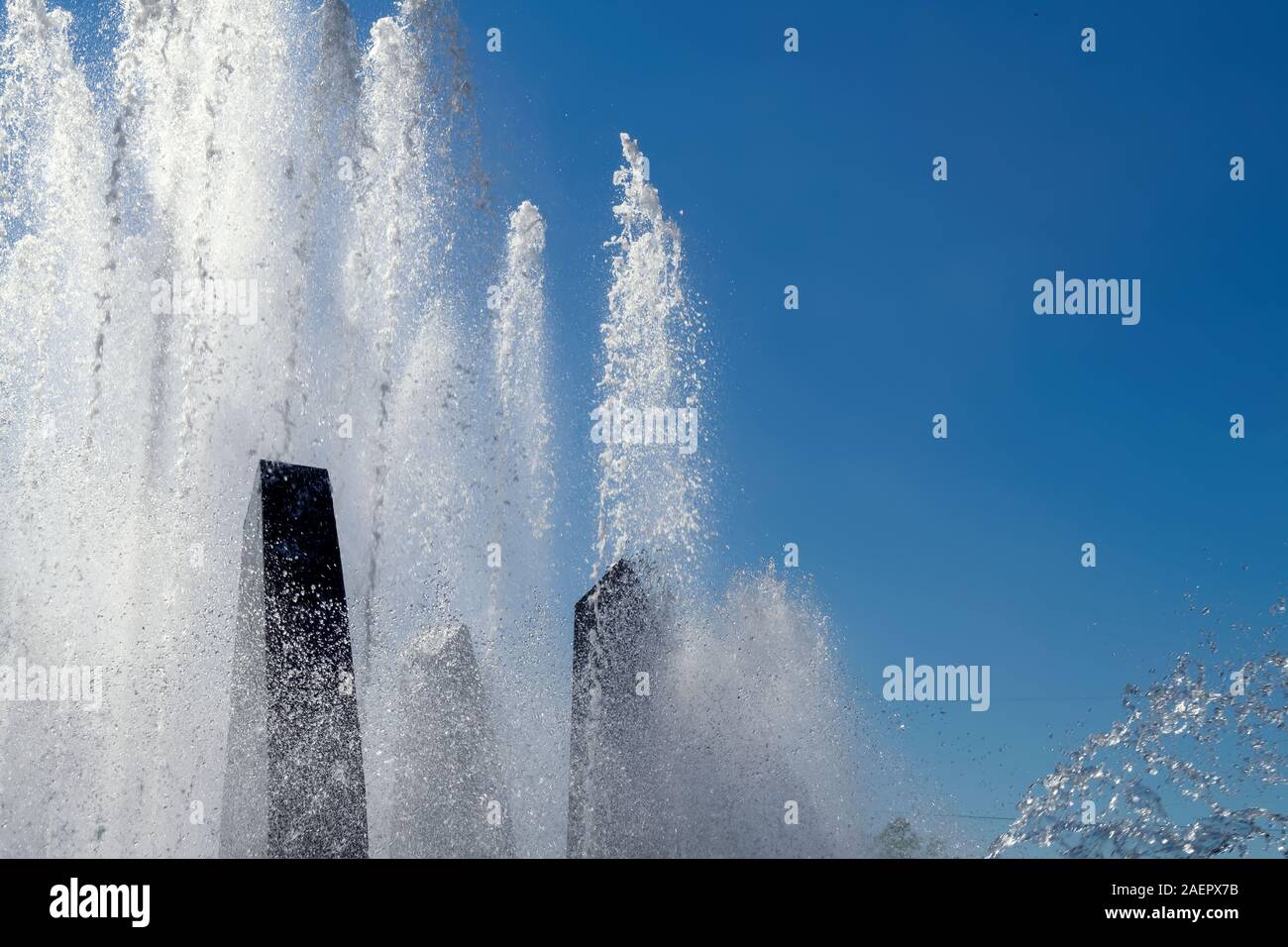 Water jet from a vertical fountain cut out against a blue sky Stock ...
