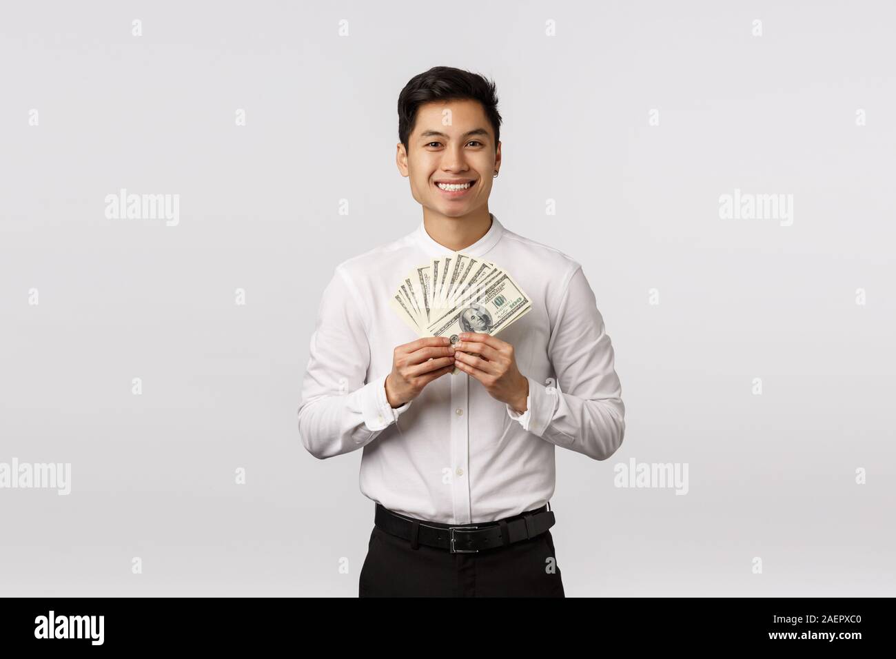 Look at that cash. Handsome happy and rich young asian guy ready spend ...