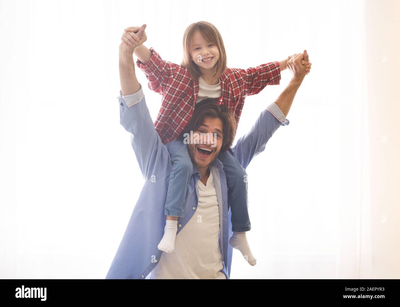 Cheerful dad and daughter having fun over white background Stock Photo ...
