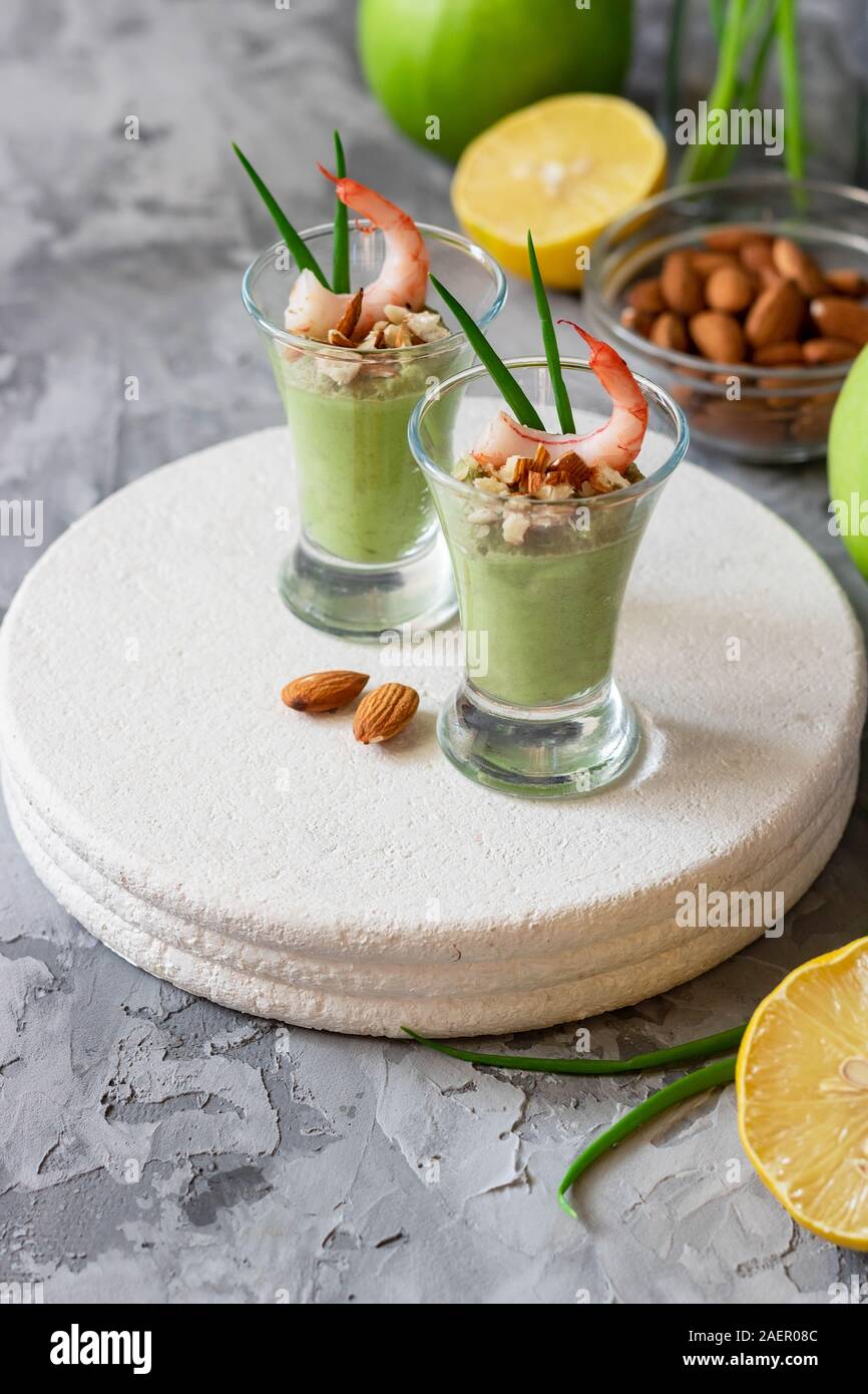 Avocado and green apple mousse with shrimp and almonds. Portion ...