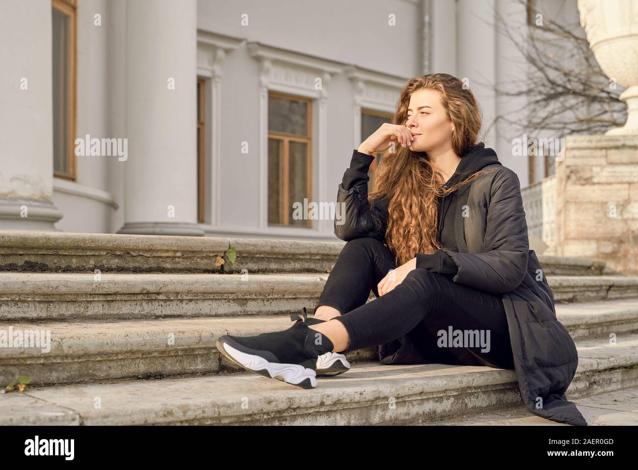 Brooding girl holding chin looks at blank space Stock Photo - Alamy