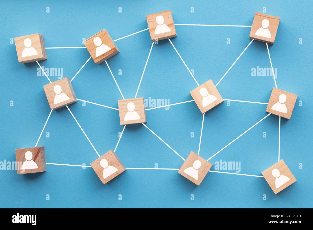 Wooden blocks connected together on a blue background. Teamwork concept ...