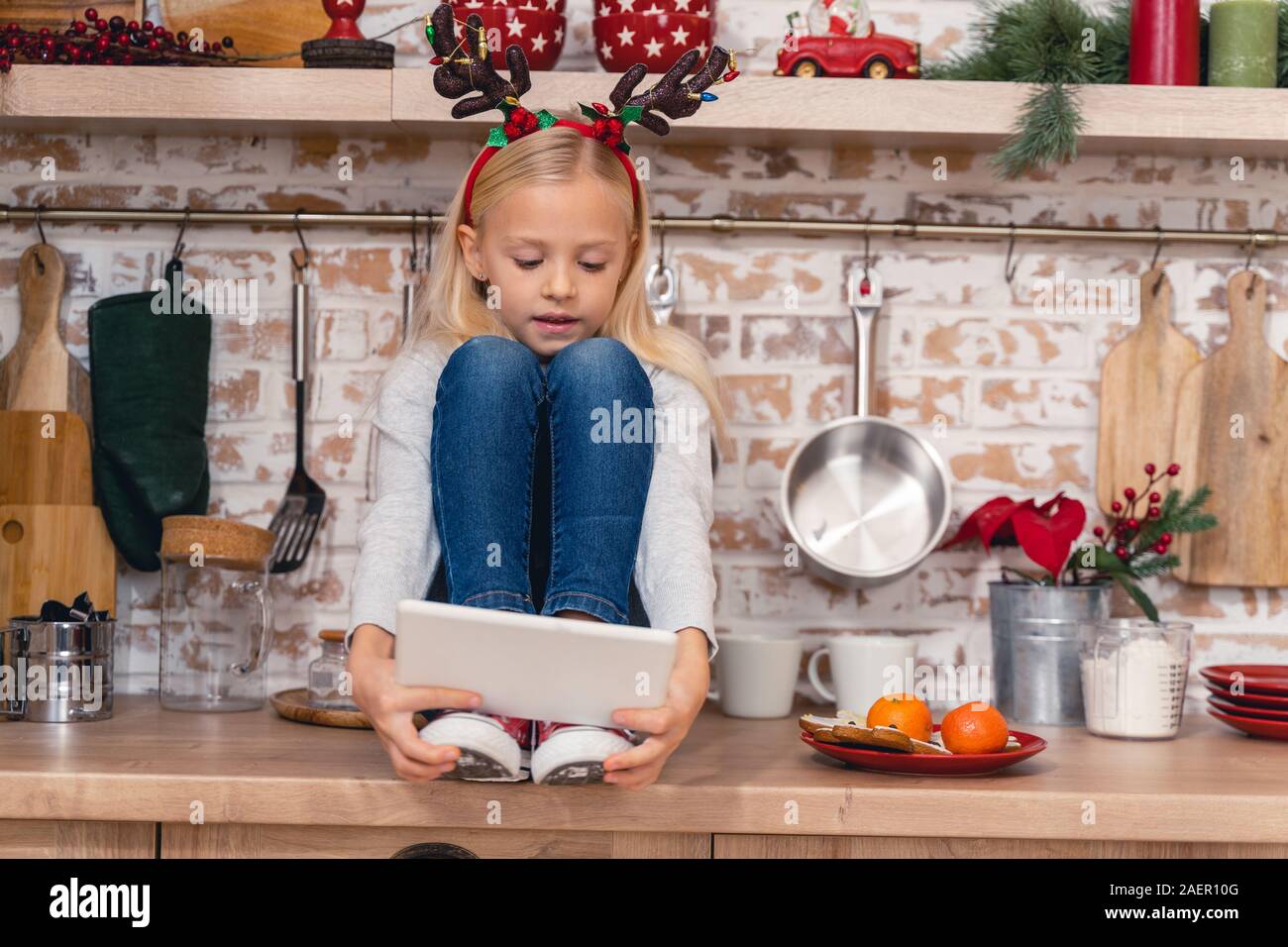 Little girl sitting on the kitchen counter Stock Photo - Alamy