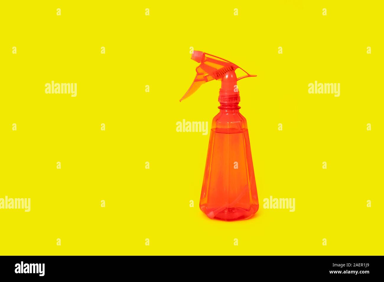 Red dispenser on the yellow background. One sprayer for cleaning or ...
