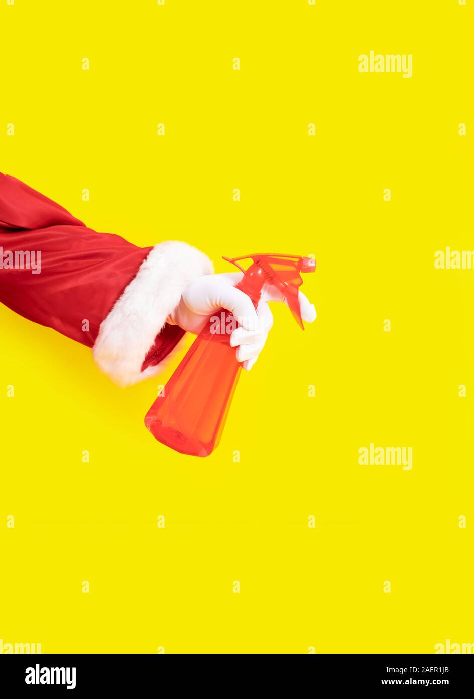 Santa Claus holds red dispenser on the yellow background. Hands of ...