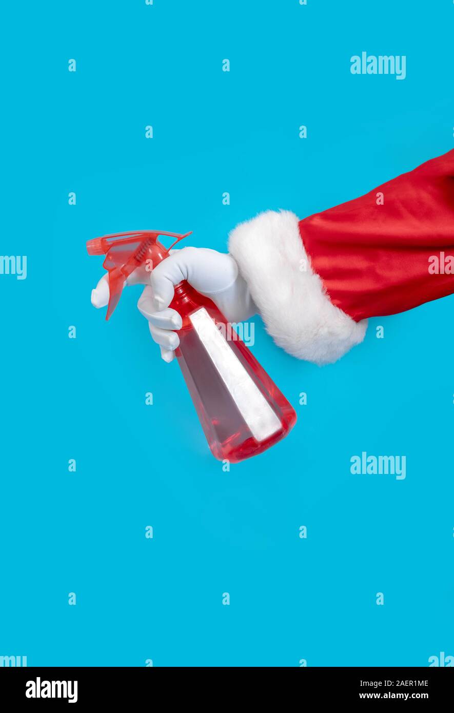 Santa Claus holds red dispenser on the blue background. Hands of Santa ...