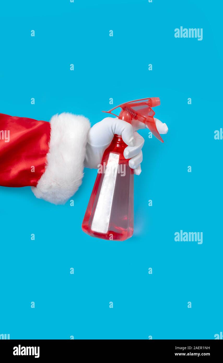 Santa Claus holds red dispenser on the blue background. Hands of Santa ...
