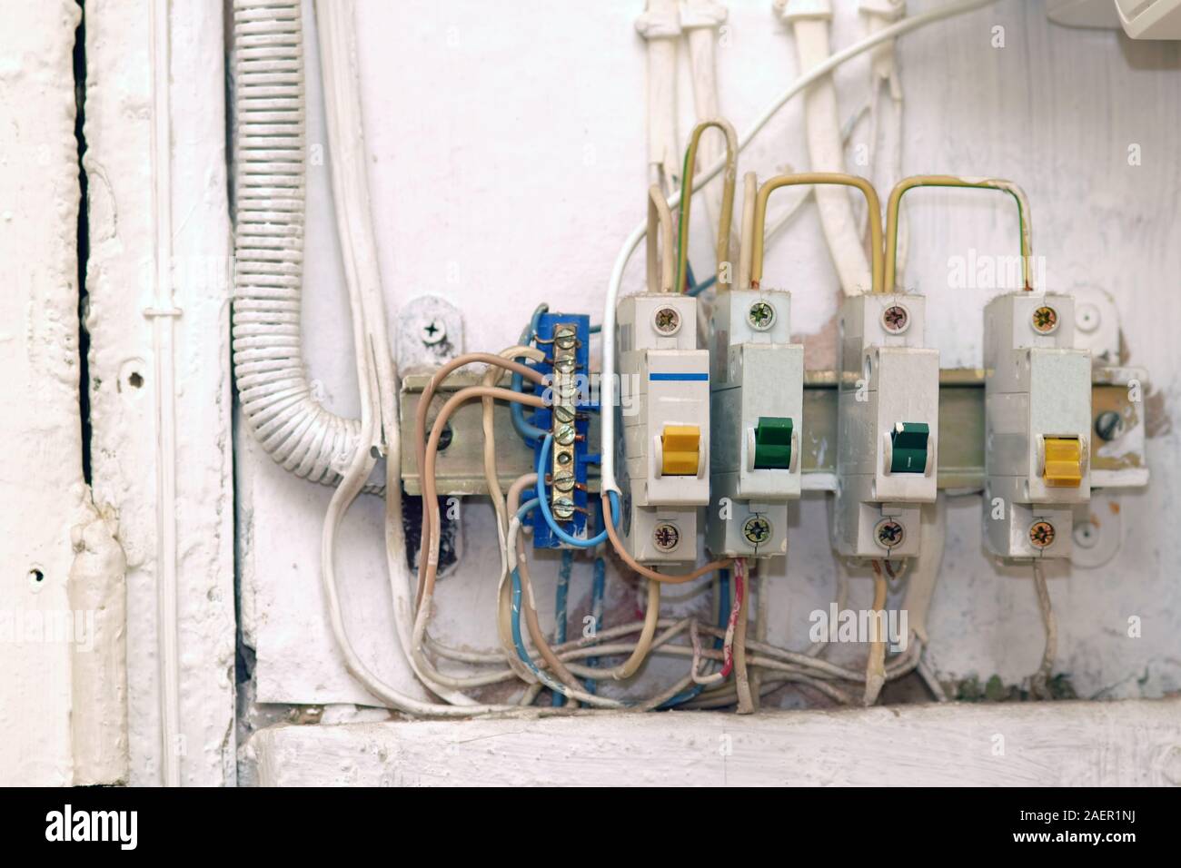 Close-up of a badly assembled fuse box mounted on the wall painted in ...
