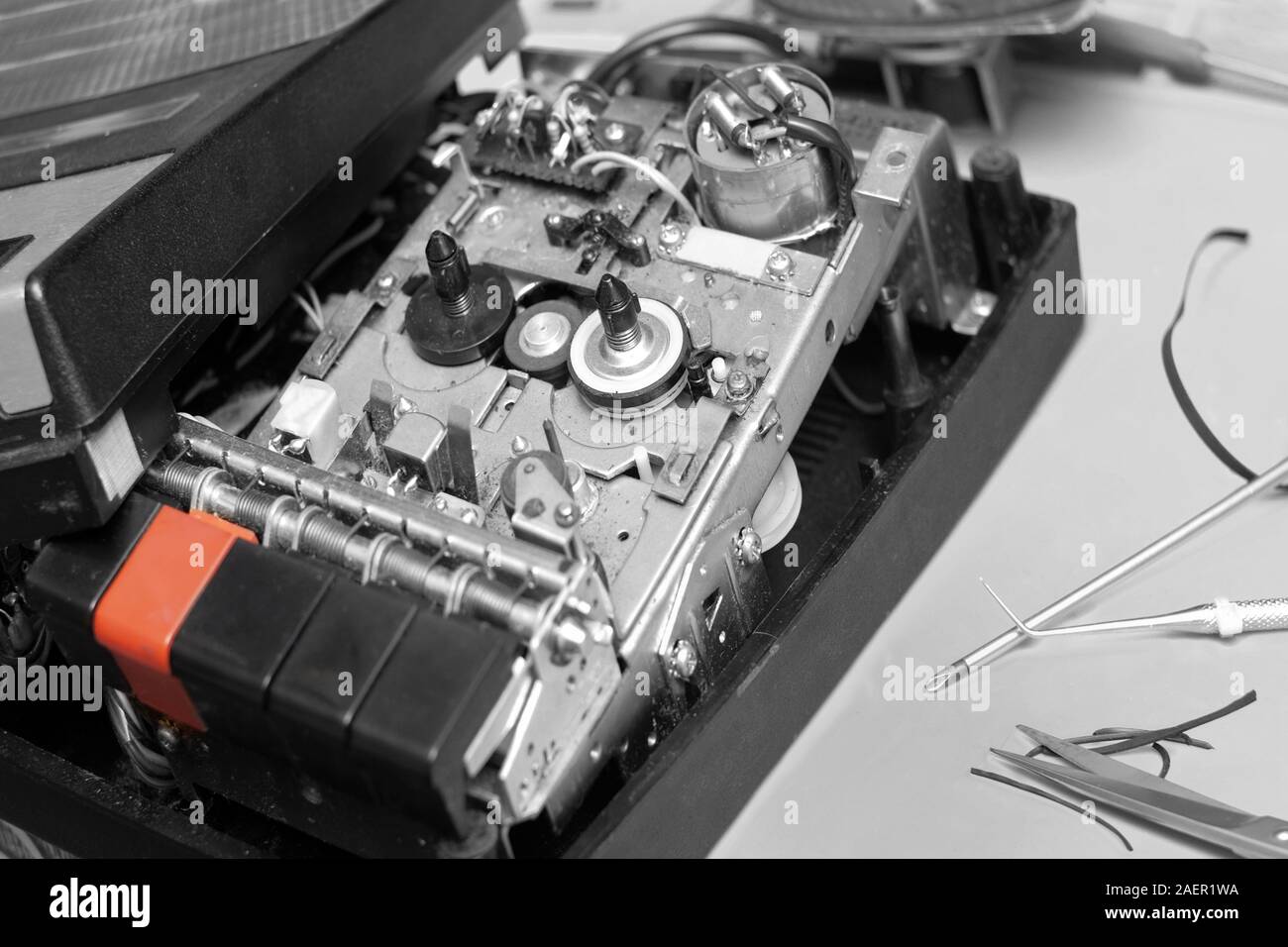 Repair of disassembled vintage cassette player, selective color image ...