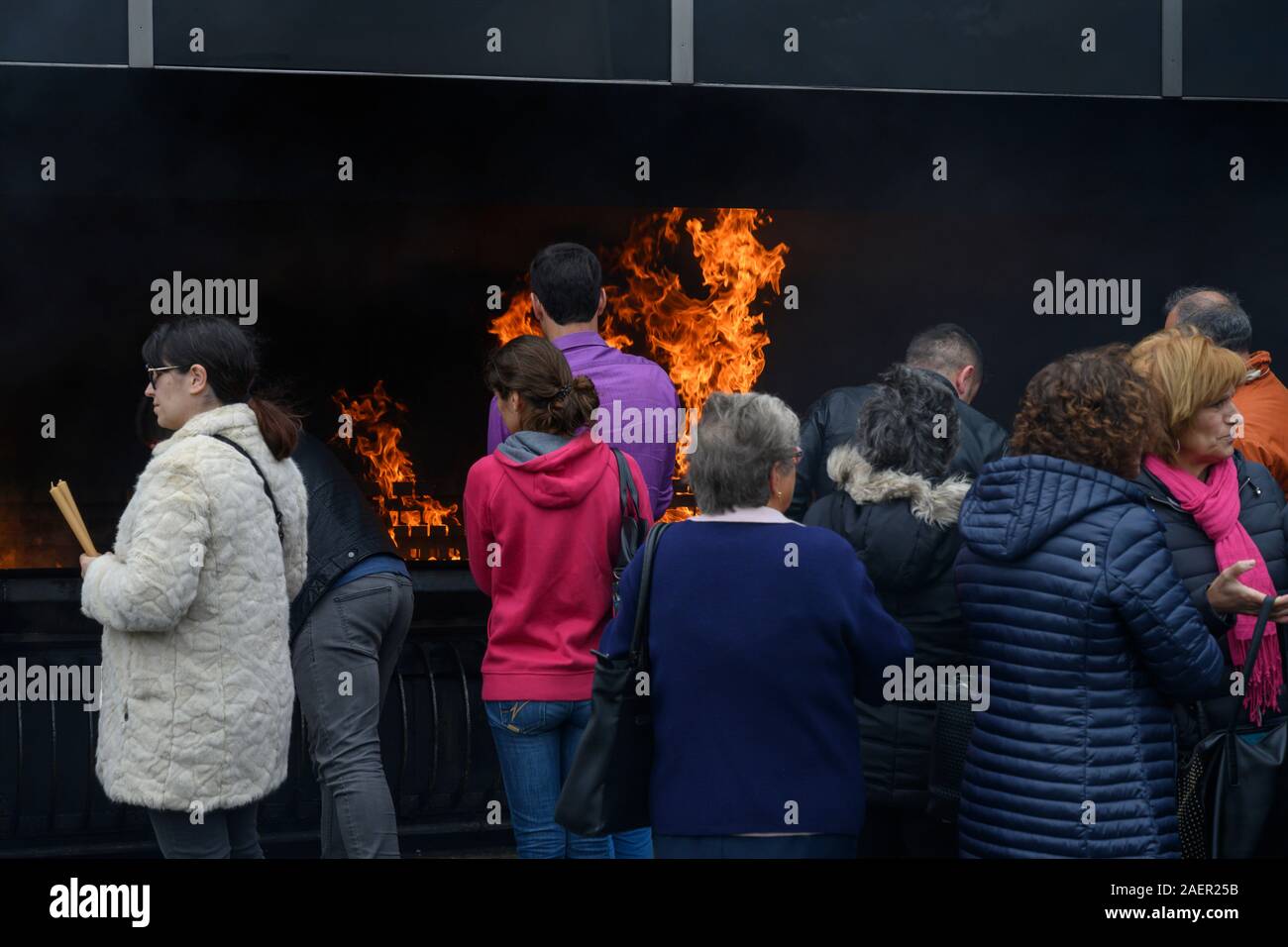 People throwing candles in fire at the Fatima Shrine, Fatima, Ourem ...