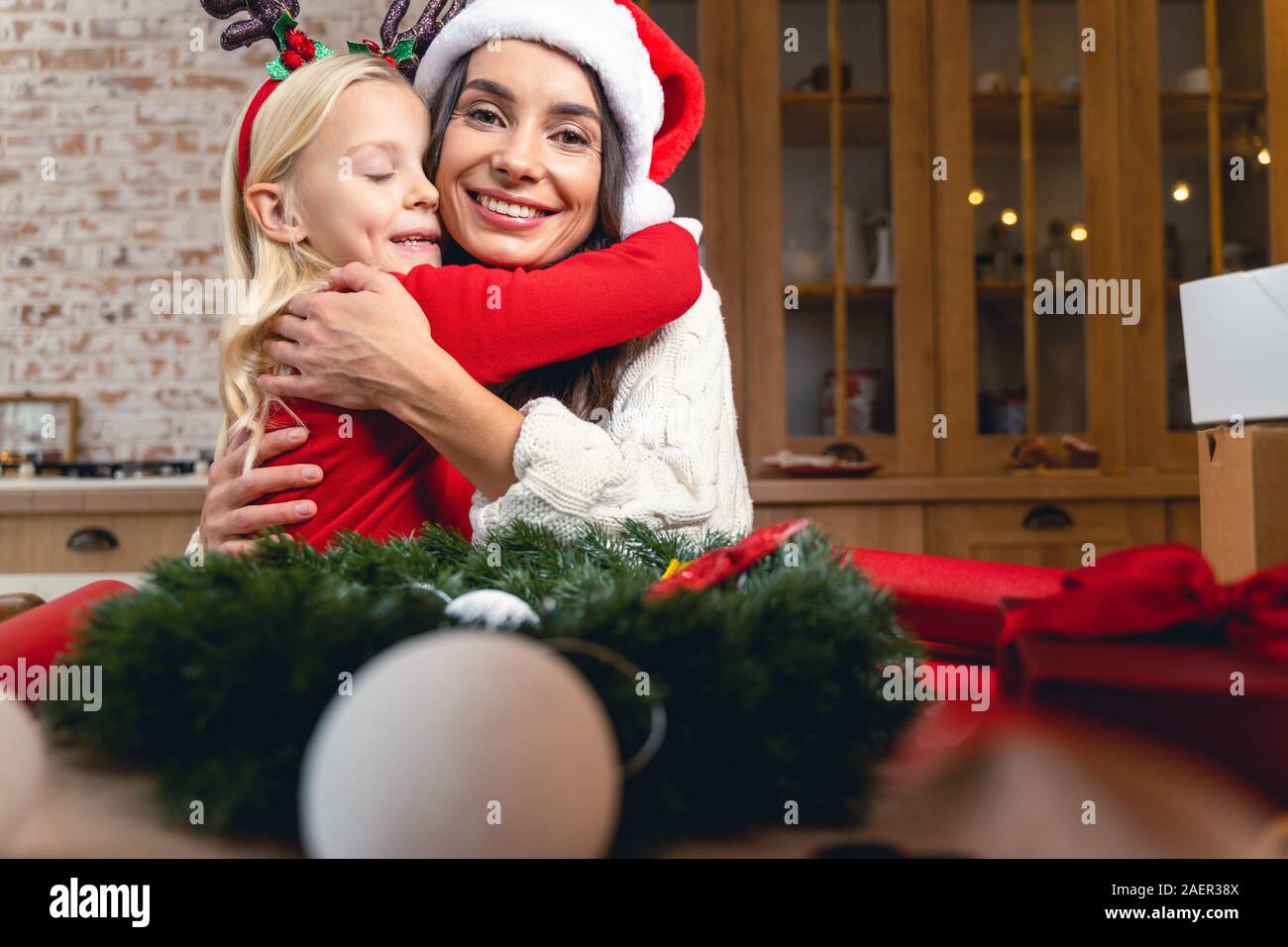 Gleeful young woman embracing tenderly her child Stock Photo - Alamy