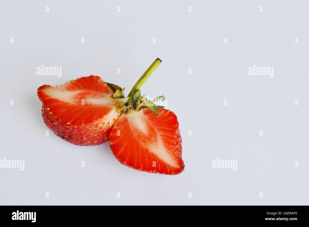 fresh strawberry half cut on white background Stock Photo - Alamy