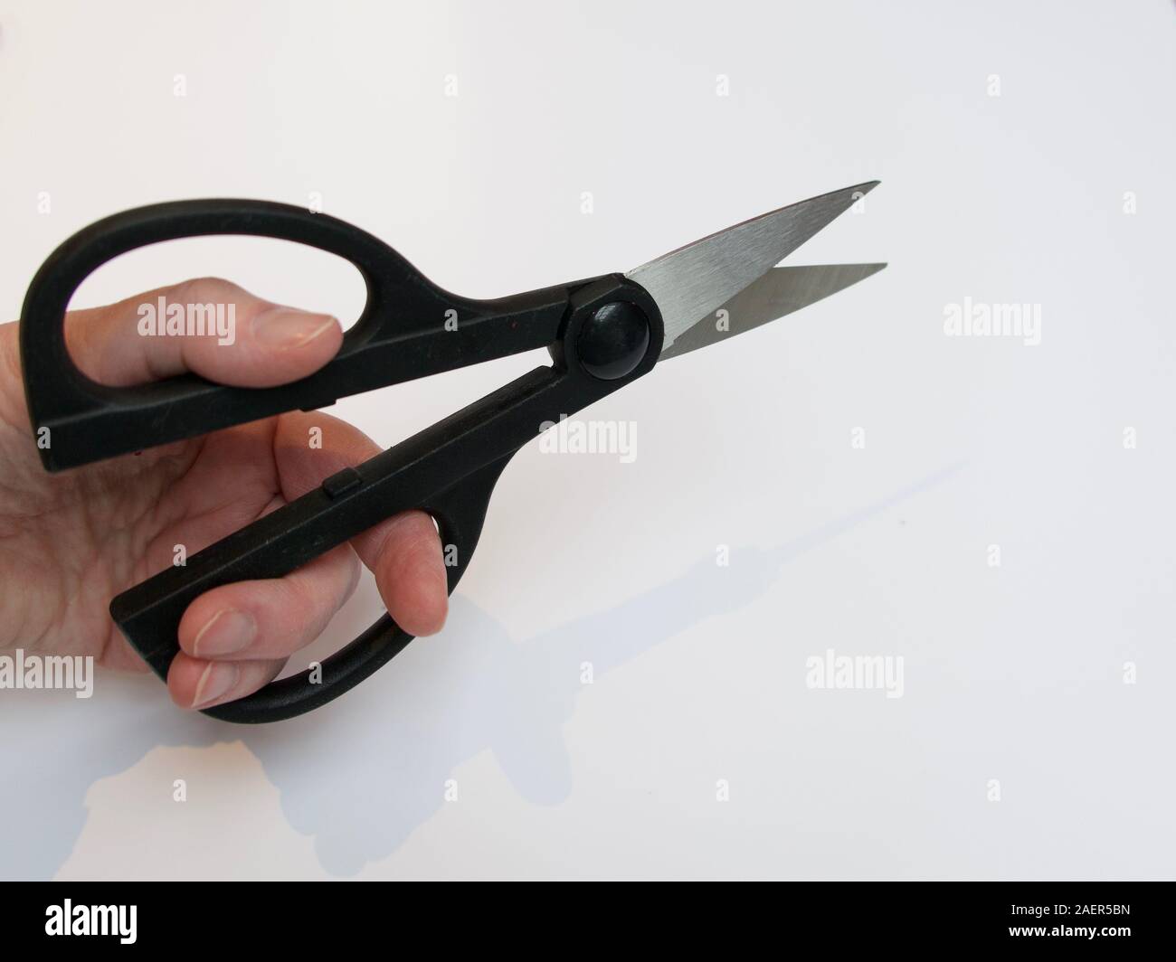 Hand cutting scissors hi-res stock photography and images - Alamy