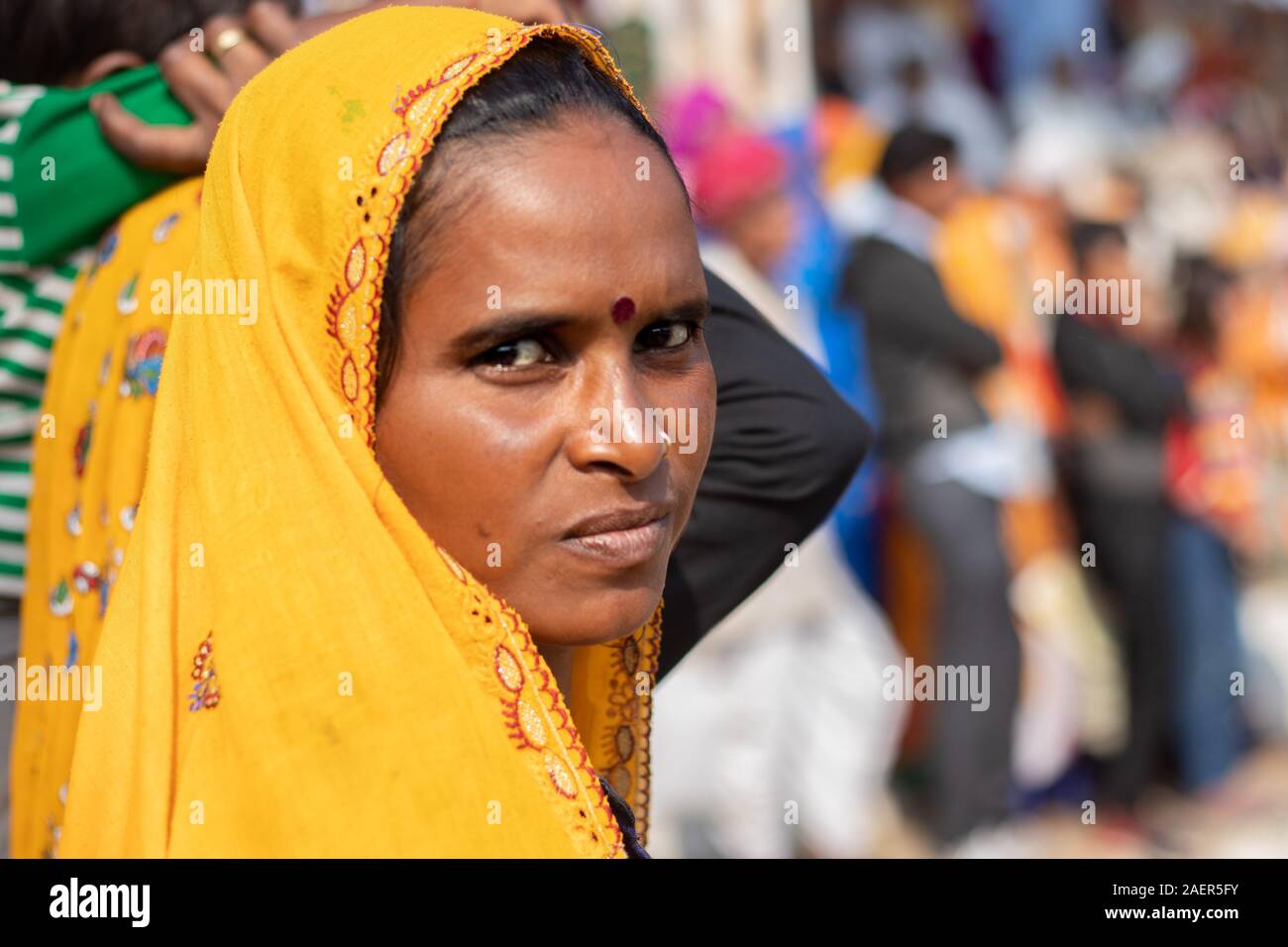 Indian women in yellow on street giving expression Stock Photo - Alamy