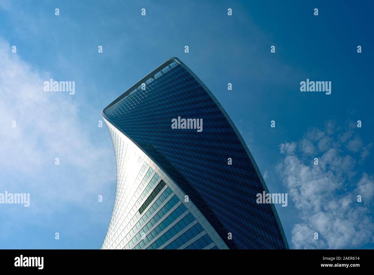 Top of twisted building against blue sky Stock Photo - Alamy