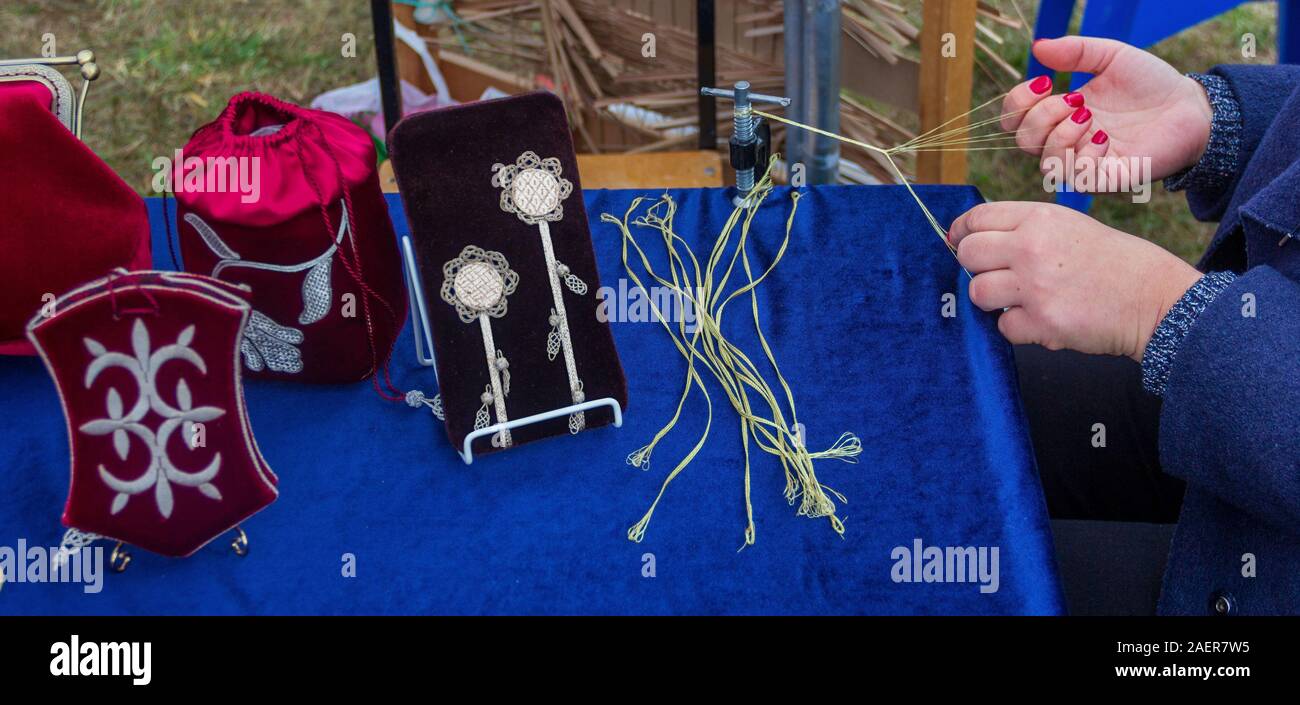 Adygea, Russia - September 21, 2019: woman's hands weaving braid from ...