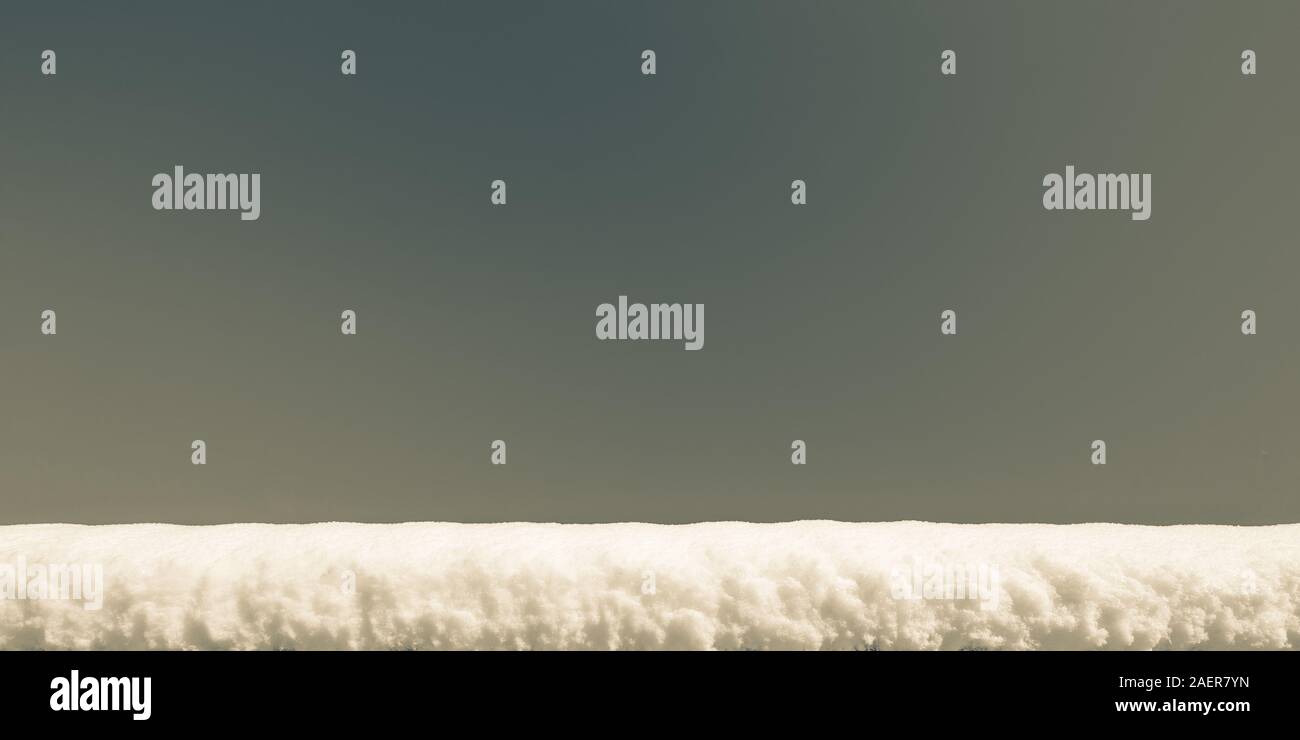 a layer snow on a against of clear blue sky, background with copy space ...