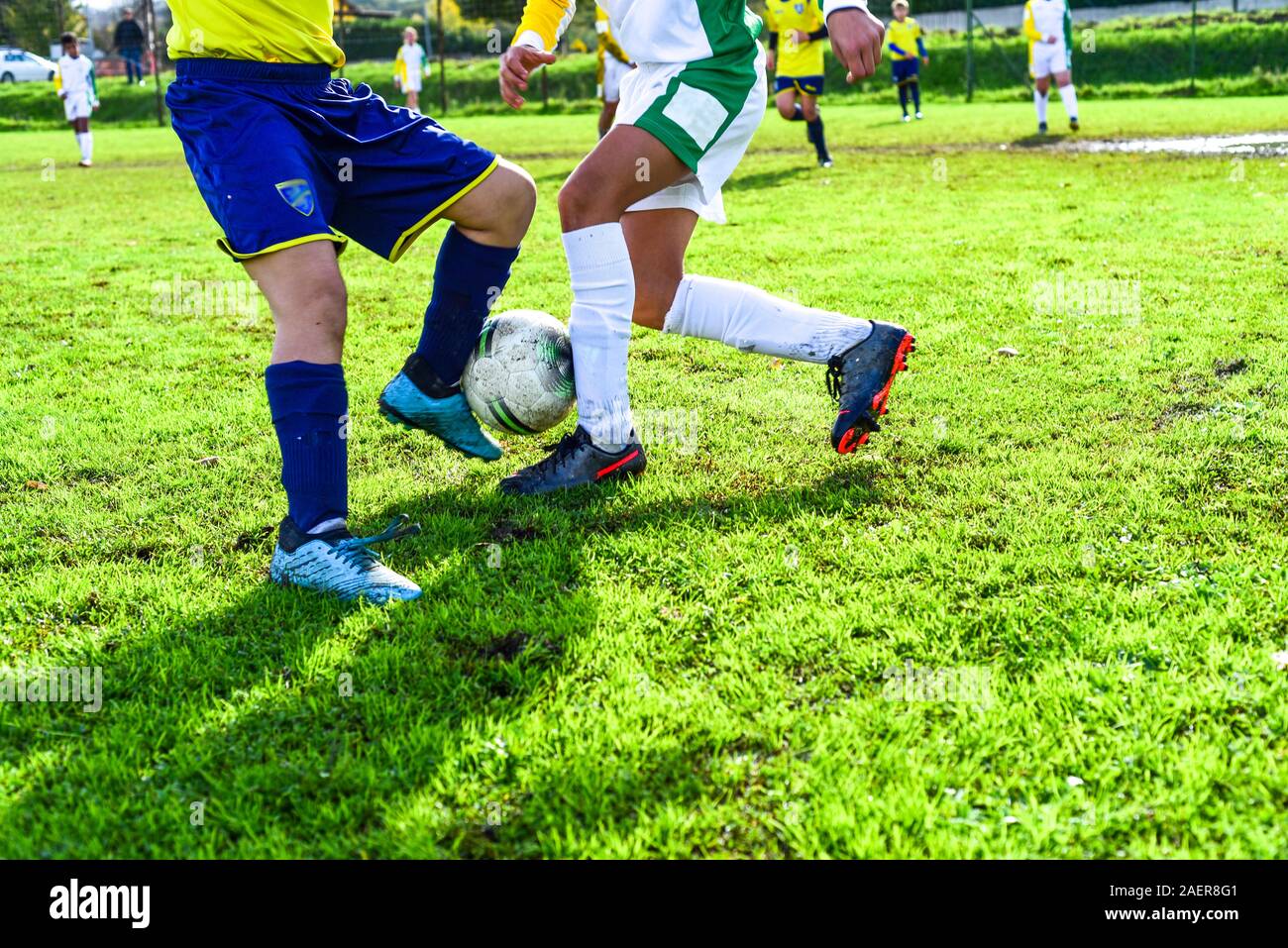 two young football players. Children play a soccer game. Legs in action ...