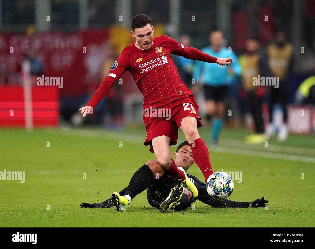 Red Bull Salzburg's Hee-Chan Hwang (bottom) makes a tackle on Liverpool ...