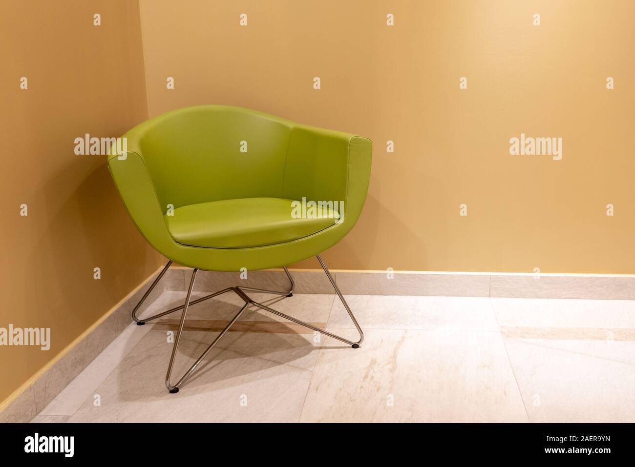 Green leather chair in modern interior standing in a corner Stock Photo ...