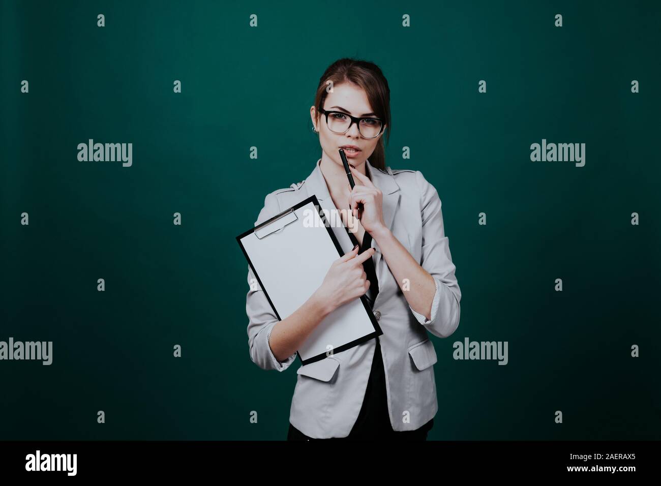 teacher with papers in green boards bussines Stock Photo - Alamy