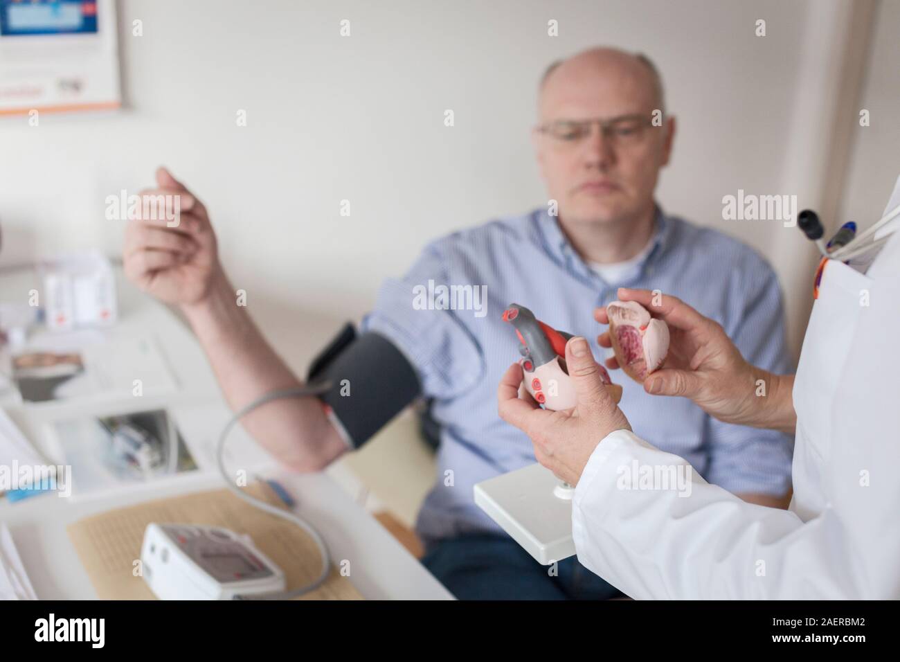 Cardiology consultation. Doctor explains male patient the diagnosis ...