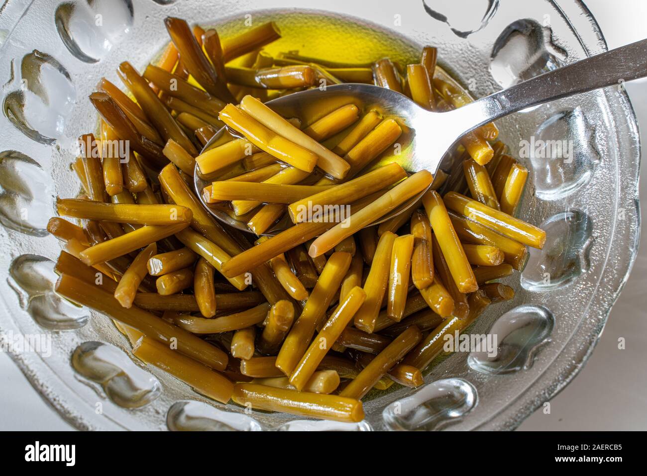 Garlic stems in olive oil Stock Photo - Alamy