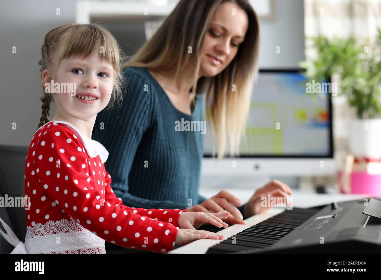 Little kid playing piano Stock Photo - Alamy