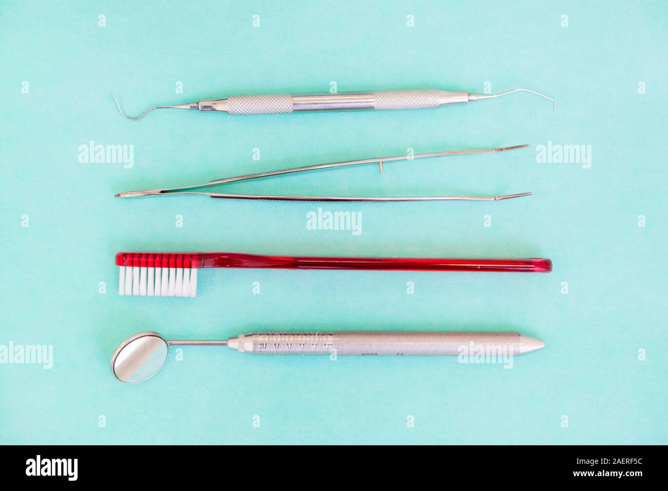 Basic professional dentist tools with a red dental care toothbrush on ...