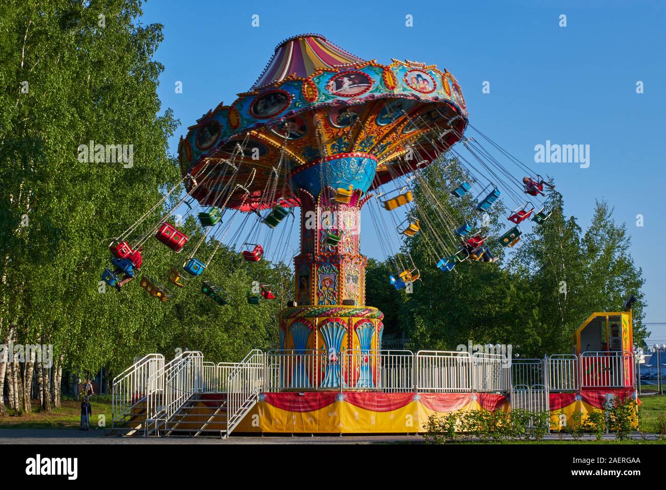 People ride the chain carousel in an amusement park. Cheboksary, Russia ...