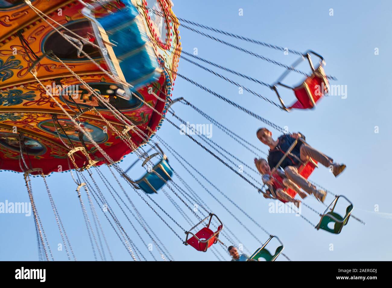 People ride the chain carousel in an amusement park. Cheboksary, Russia ...