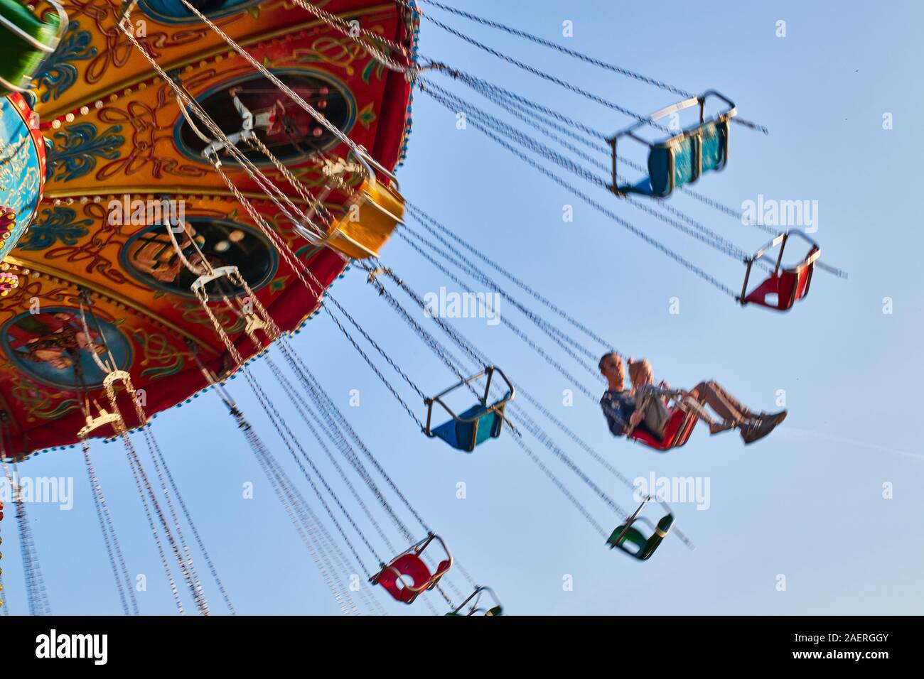 People ride the chain carousel in an amusement park. Cheboksary, Russia ...