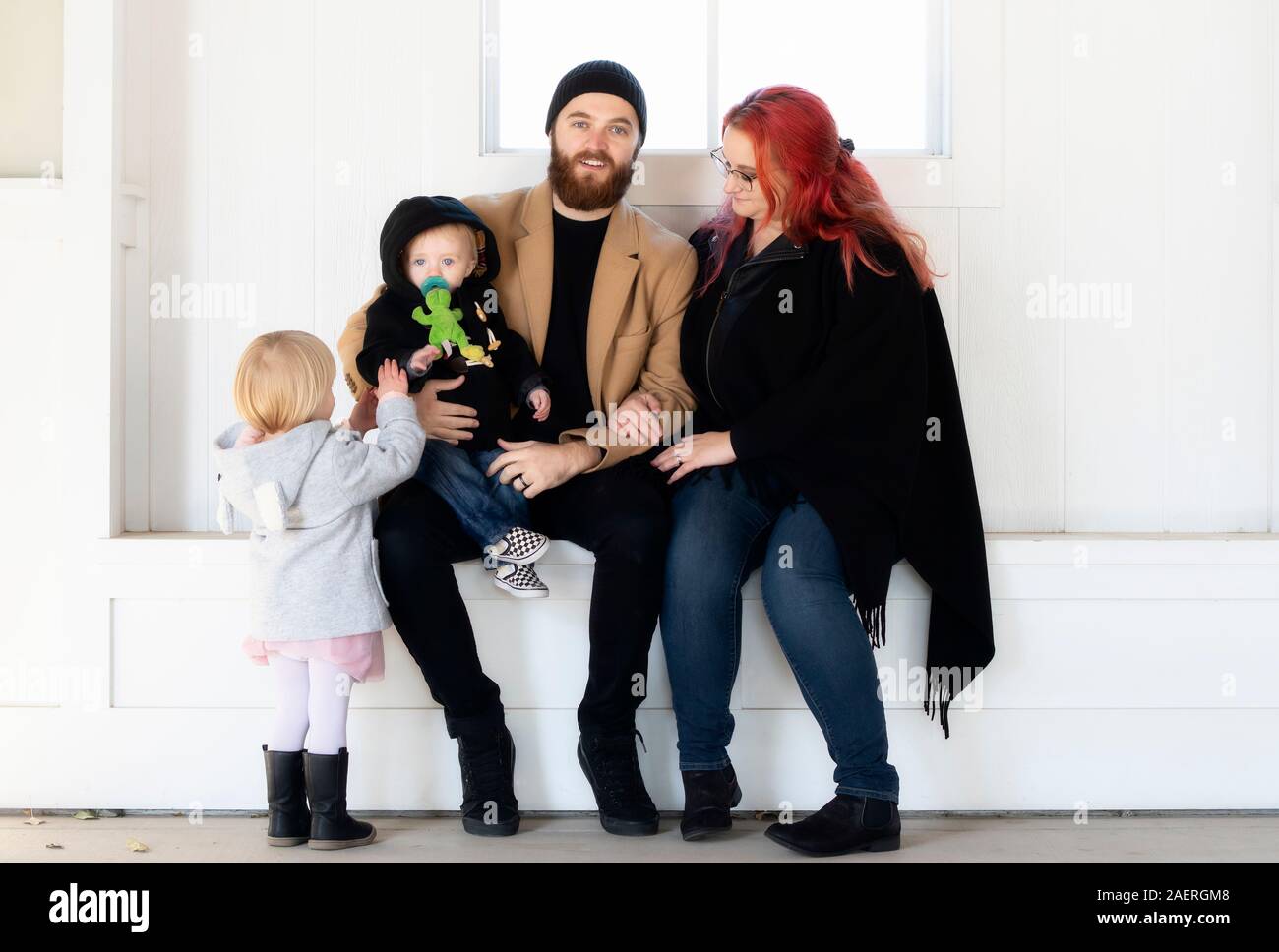 Millennial Father and Mother with Two Young Children, Dressed in Warm ...