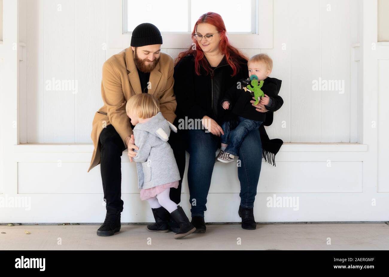 Millennial Father and Mother with Two Young Children, Dressed in Warm ...
