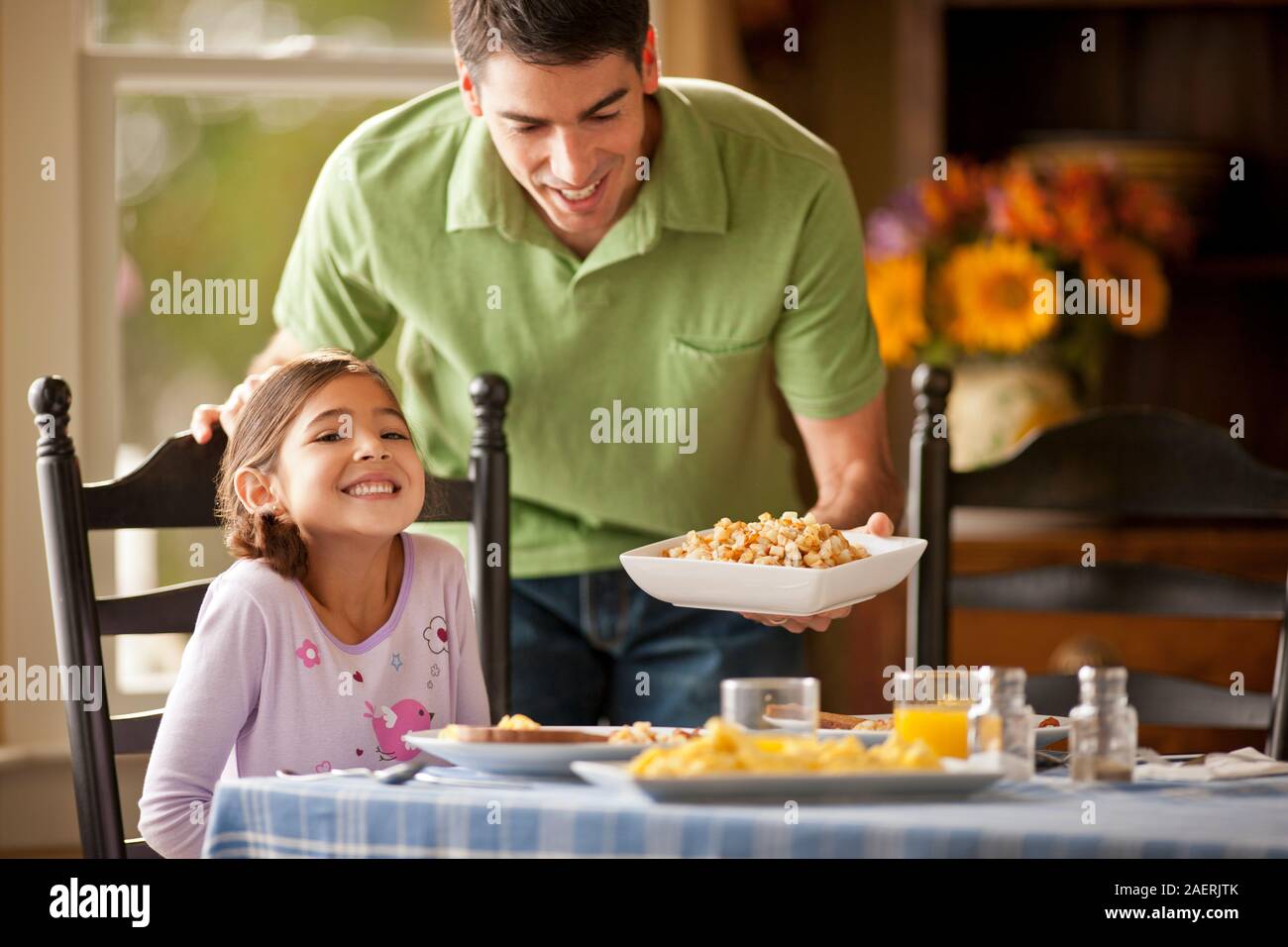 Happy family having fun eating at a dining table Stock Photo - Alamy