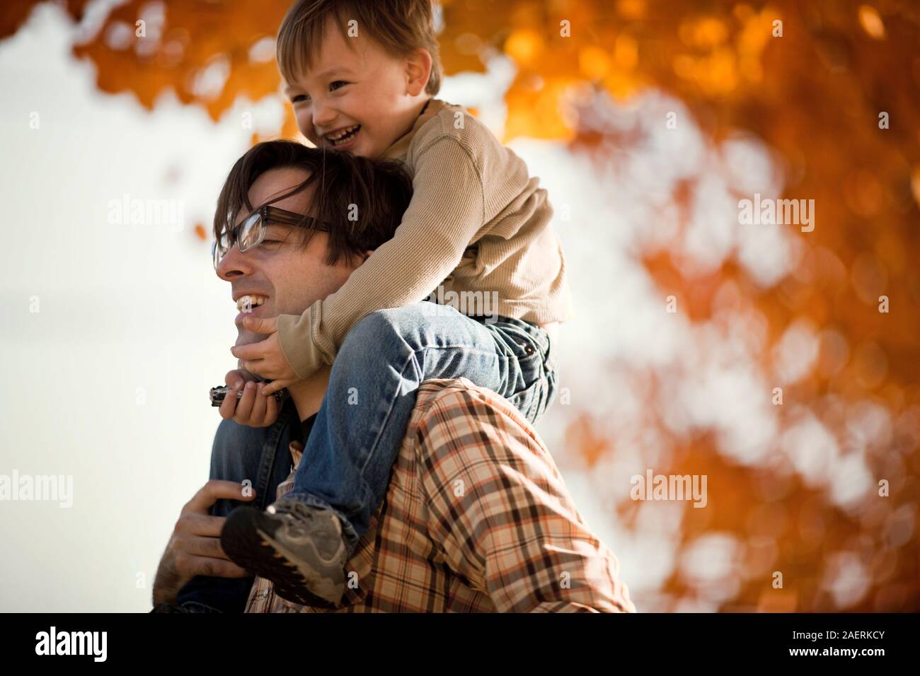 Father giving son a piggyback ride Stock Photo - Alamy