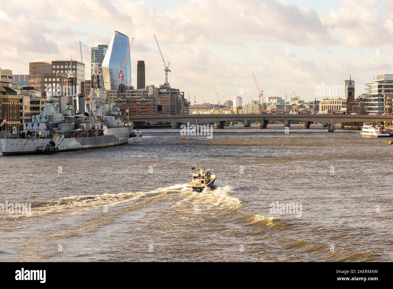 Police launch boat heading towards London Bridge on River Thames ...