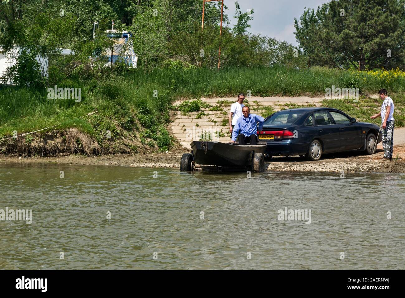 Novi Becej, Tisa River, Serbia May 14, 2017. A group of men throws a fishing boat into the river ...