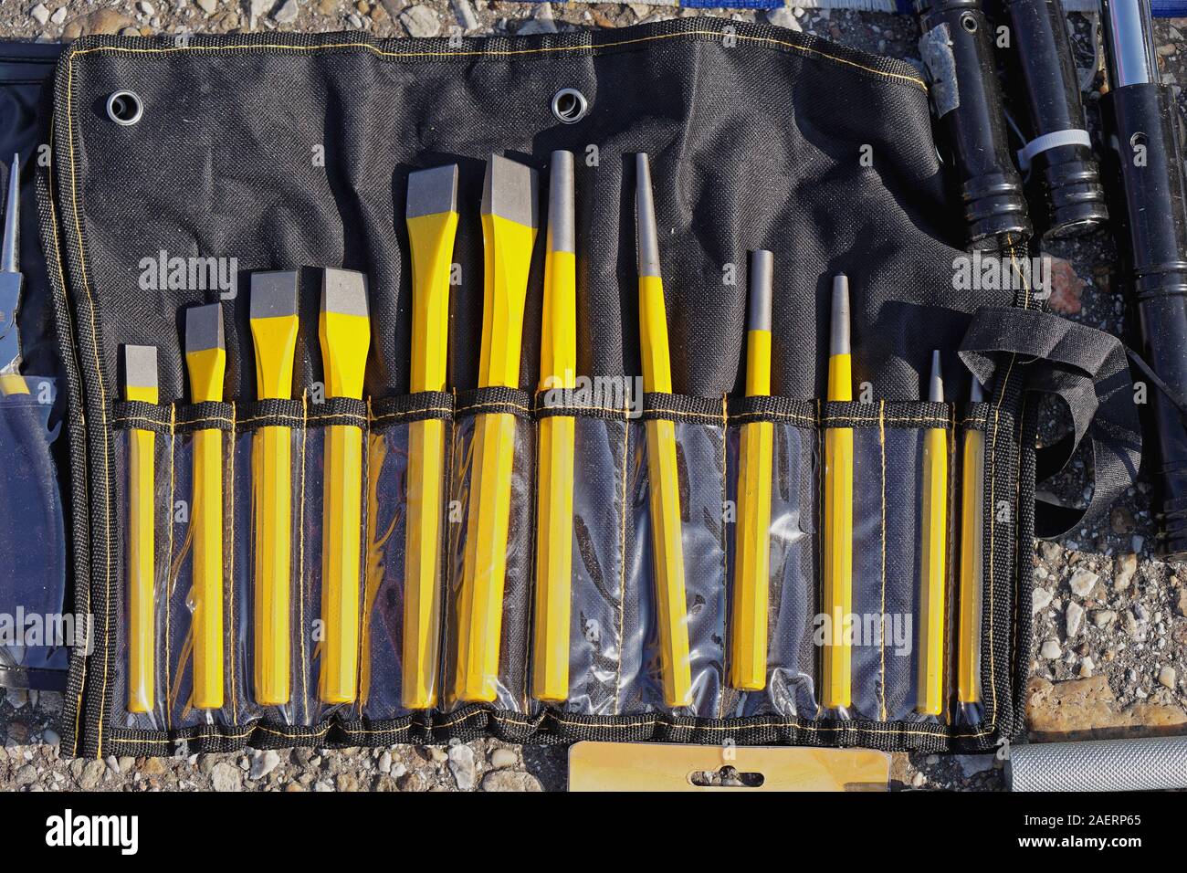 Various sizes of yellow chisels in pouch set Stock Photo - Alamy