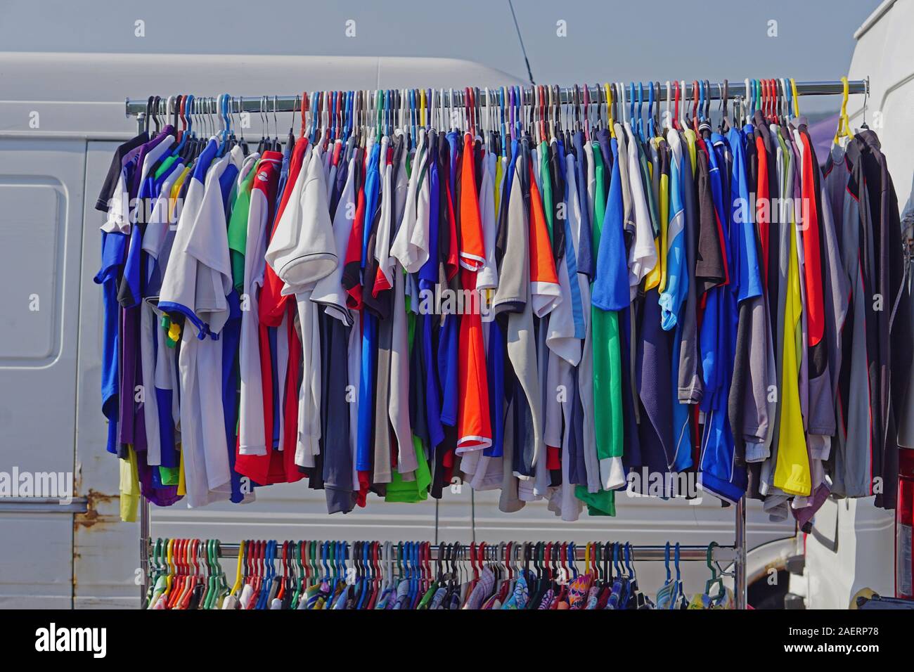 Colorful sports team shirts hanging at clothes rails Stock Photo - Alamy