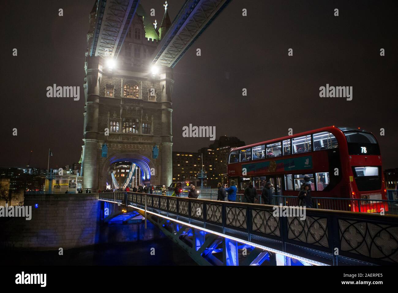 Red bus crosses Tower Bridge at night GV General View, London Stock ...