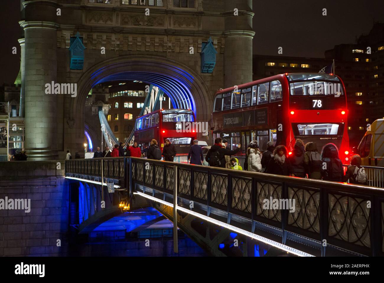 Red busses crosses Tower Bridge at night GV General View, London Stock ...