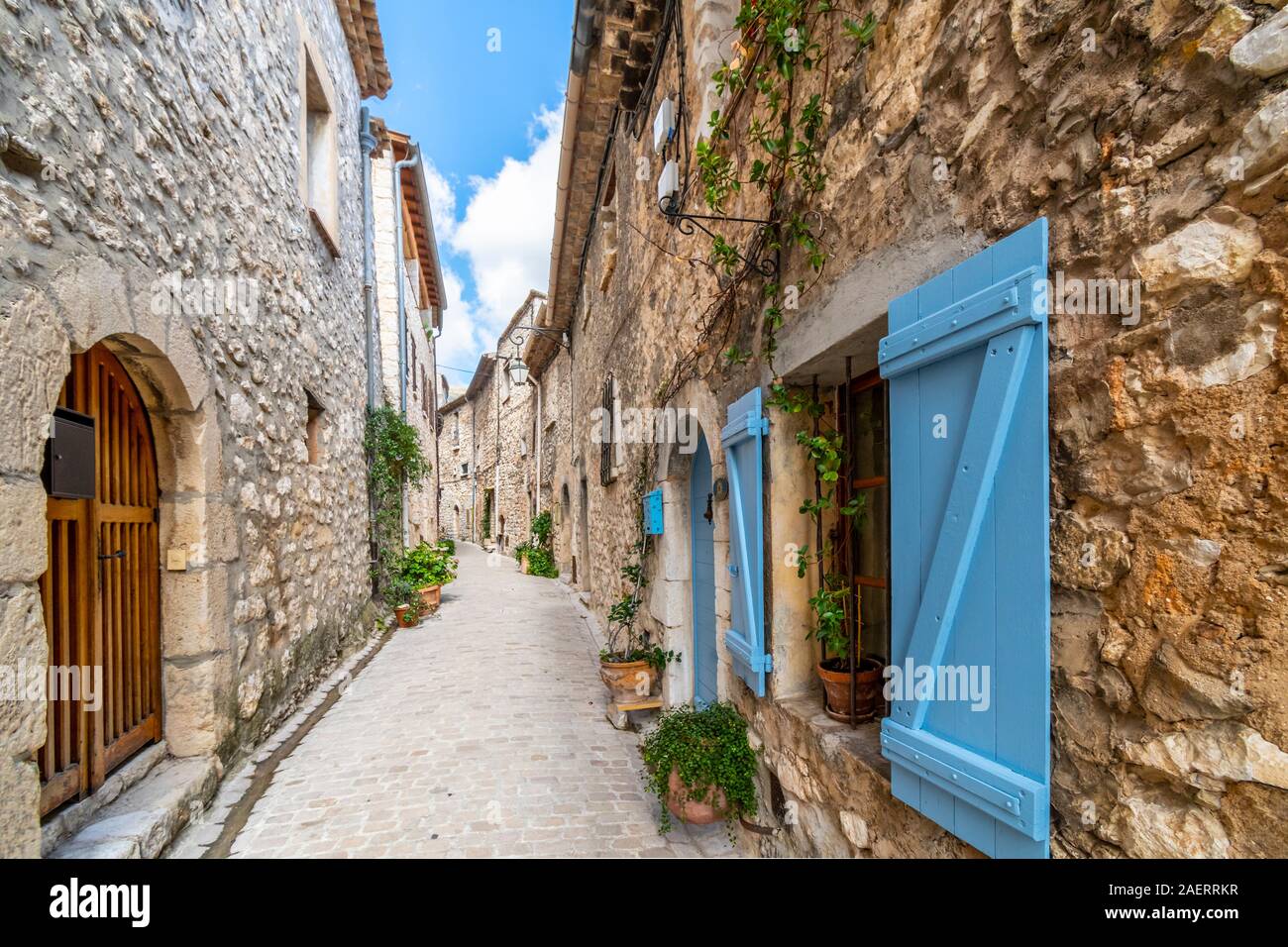 A typical narrow, winding alley with French Bleu shutters in the ...