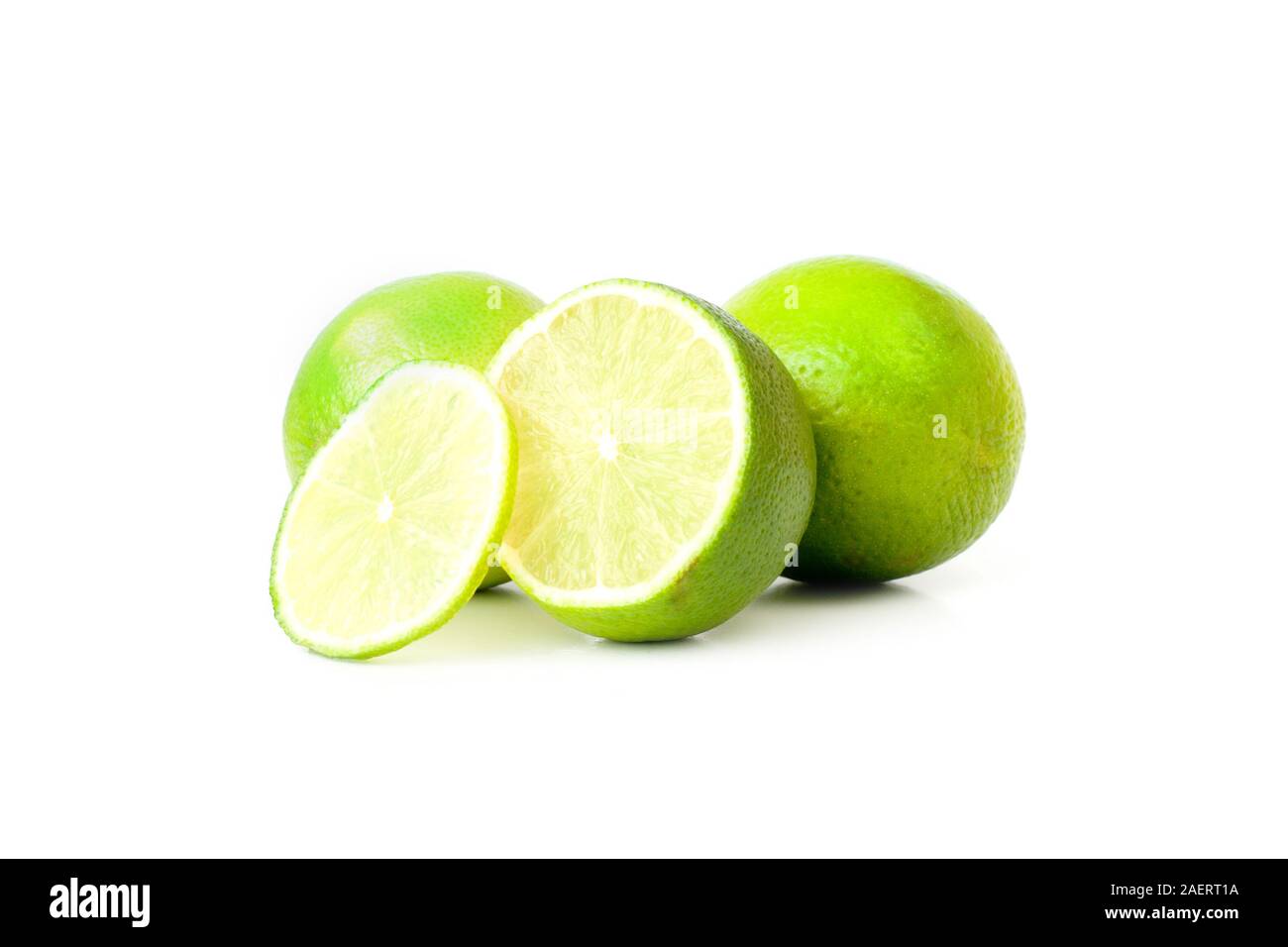 Two whole limes, one half lime, isolated on white Stock Photo - Alamy