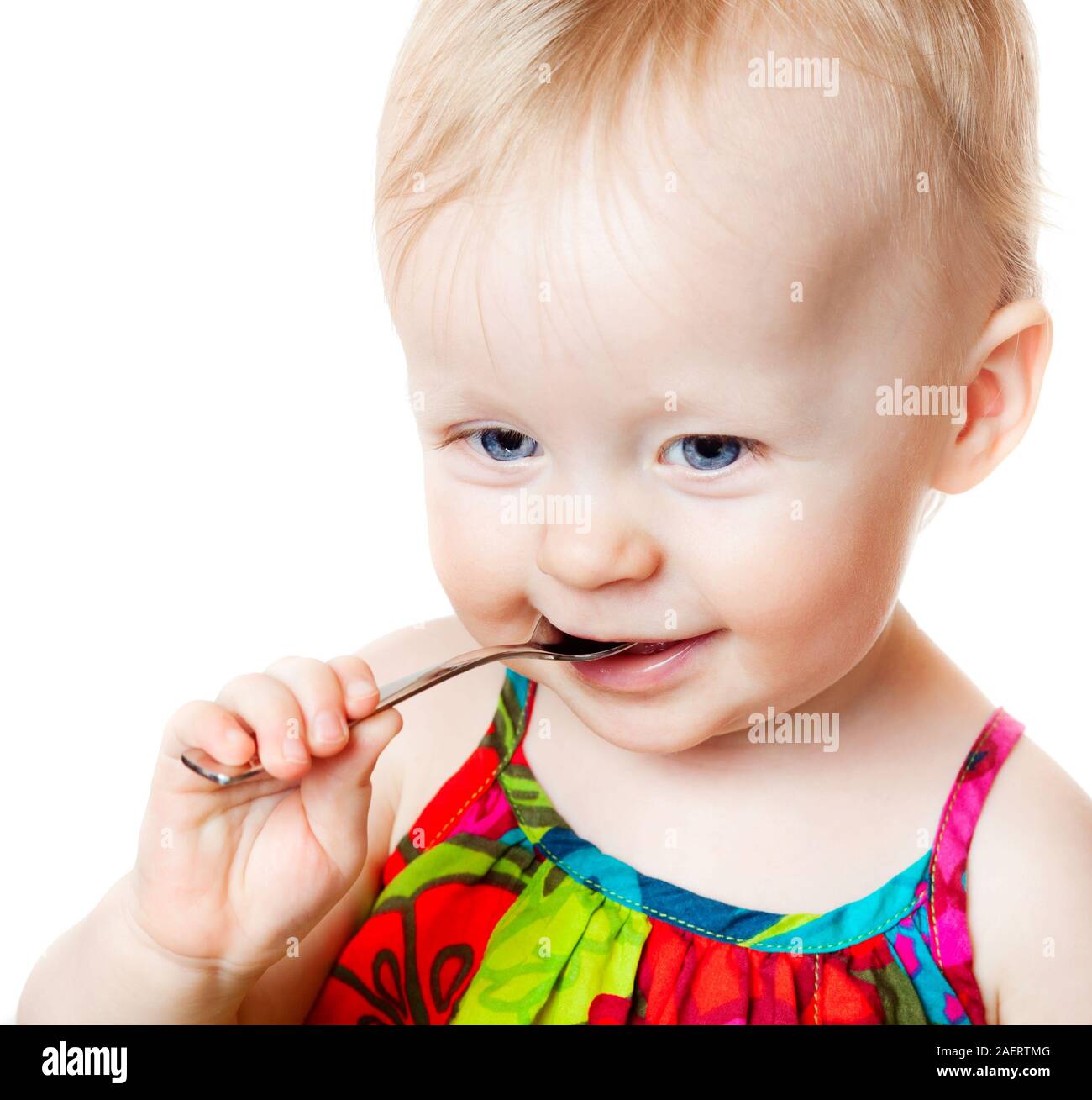Little baby girl eating with spoon, isolated over white Stock Photo - Alamy