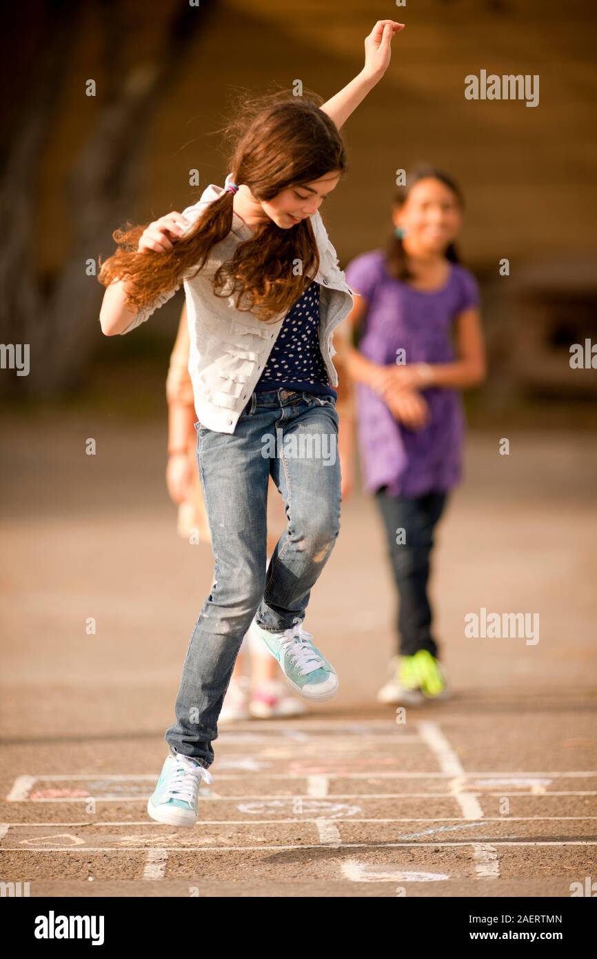 Girls playing hopscotch Stock Photo - Alamy