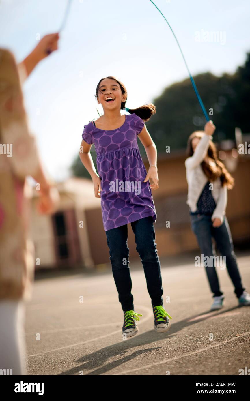 Girls playing jumprope Stock Photo - Alamy