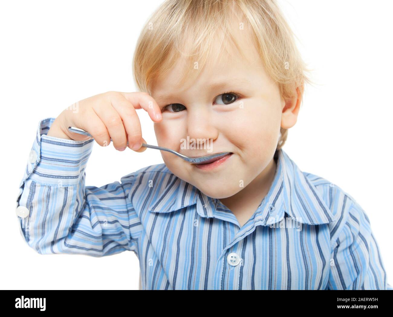 Cute little child eating with spoon, isolated over white background ...